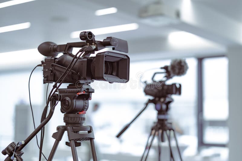 Two Broadcast Cameras Ready on a Tripod for a Conference or Live Event ...
