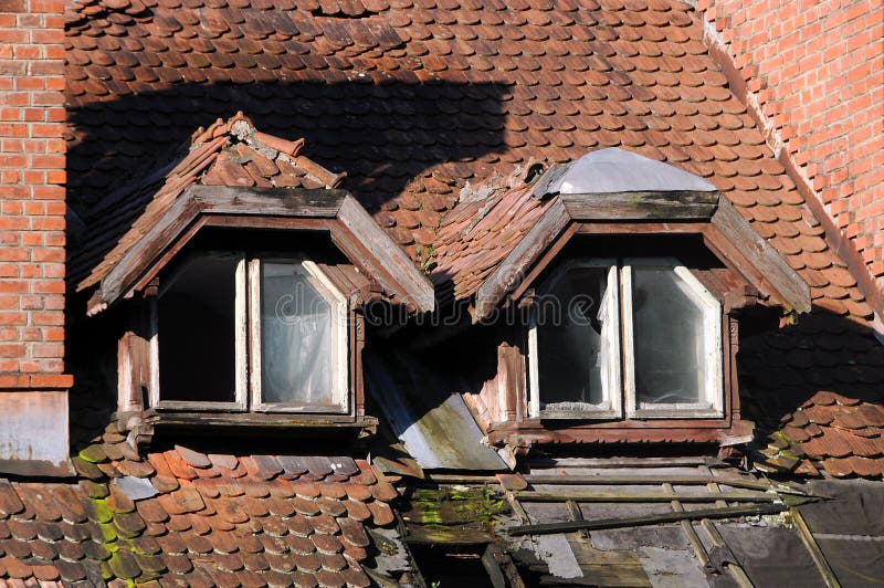 Two broken attic windows stock image. Image of city - 261710431