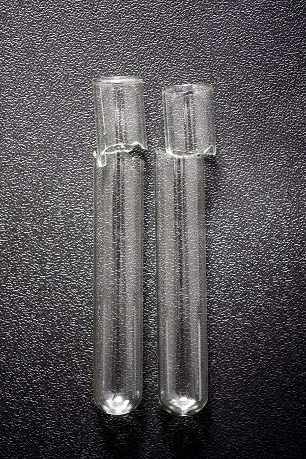 Two Broken Glass Test Tubes on a Black Surface Stock Photo - Image of ...