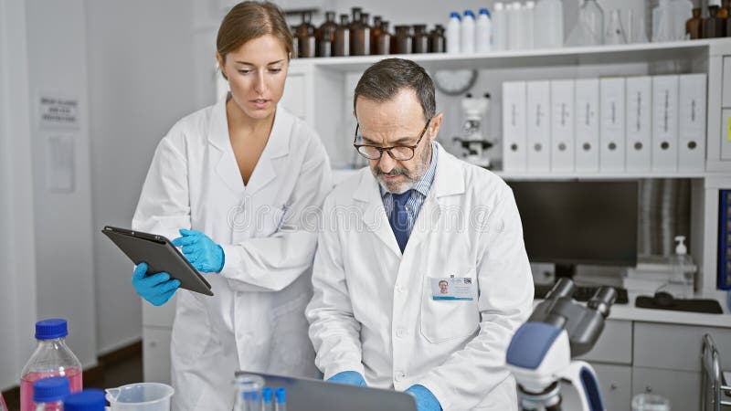 Two Brooding Scientists Huddled Together at Their Lab, Engrossed in ...