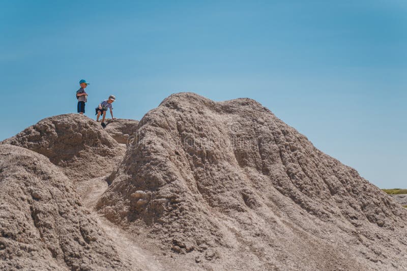 Two Brothers Climbing the Rock Formations of Badlands National Park ...