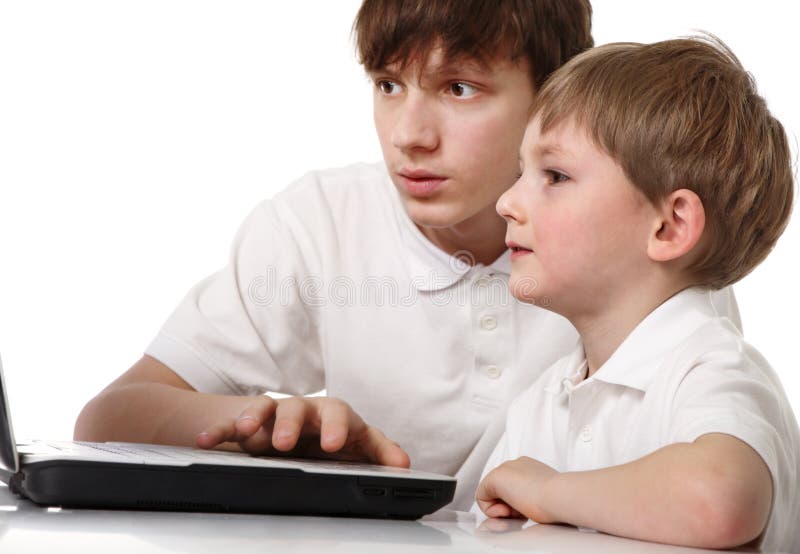 Two brothers with laptop stock photo. Image of sitting - 13233674