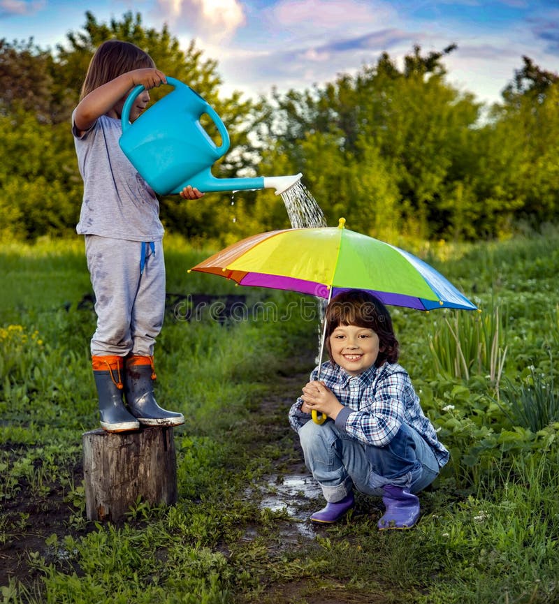Two Brothers Play in Rain Outdoors Stock Image - Image of caucasian ...
