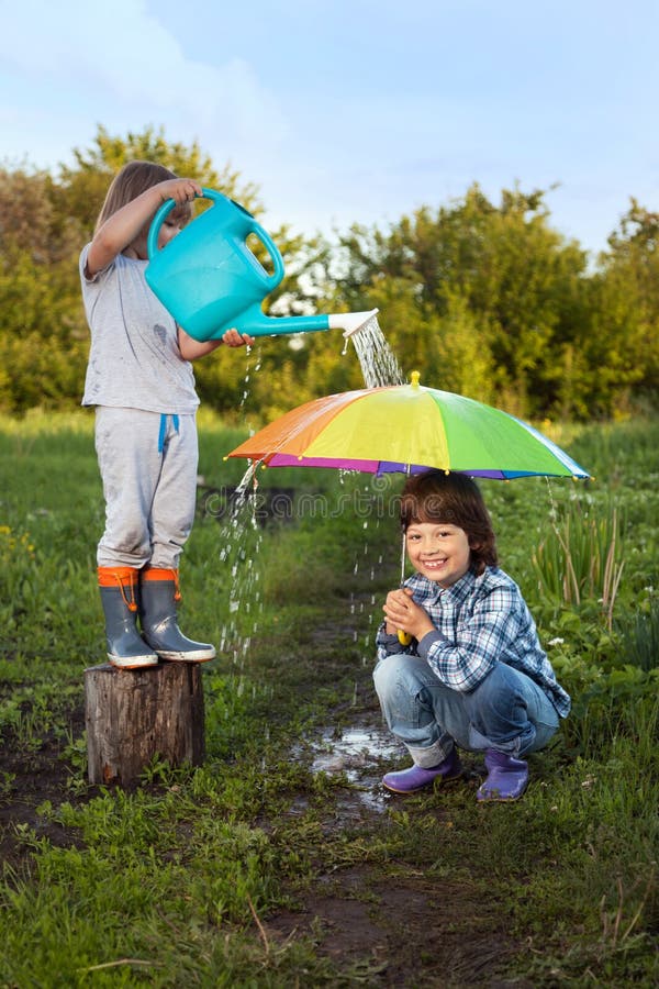 Two Brothers Play in Rain Outdoors Stock Image - Image of activity ...