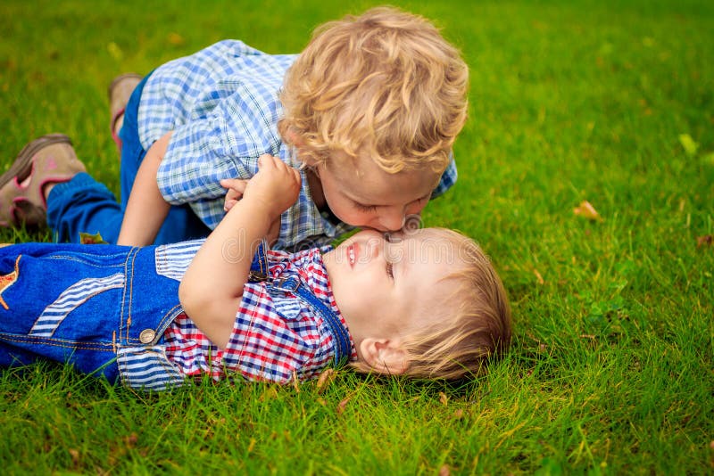Two Brothers Playing on the Lawn in the Park Stock Image - Image of ...