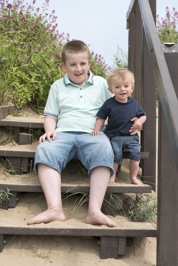 Two Brothers Playing Together on the Beach Stock Photo - Image of ...