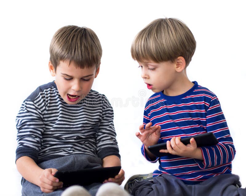 Two Brothers Playing Video Games on Tablets Stock Photo - Image of ...