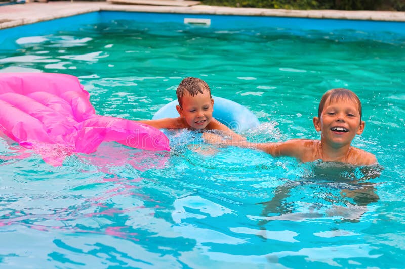 Two brothers in the pool stock image. Image of playing - 32116991