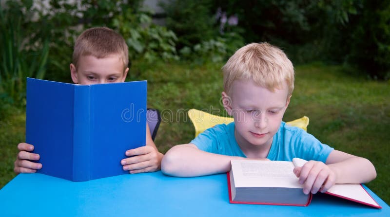 Two Brothers Reading Books Outdoors Stock Photo - Image of cheerful ...