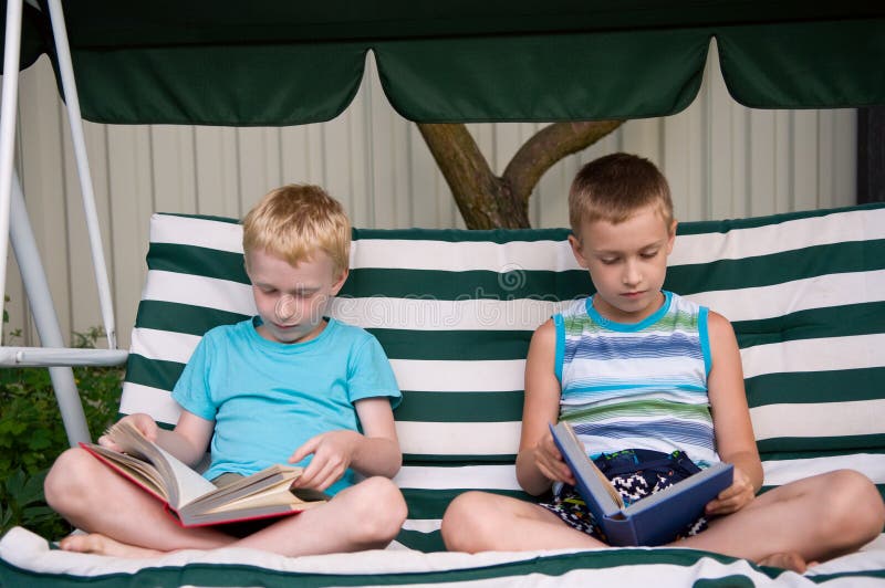 Two Brothers Reading Books Outdoors Stock Photo - Image of garden ...