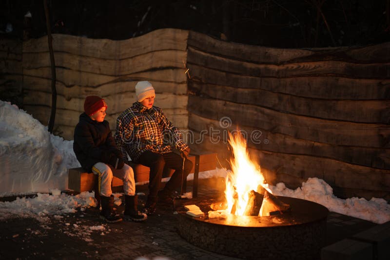 Two Brothers Sit by the Fire Pit in Winter Night Stock Image - Image of ...