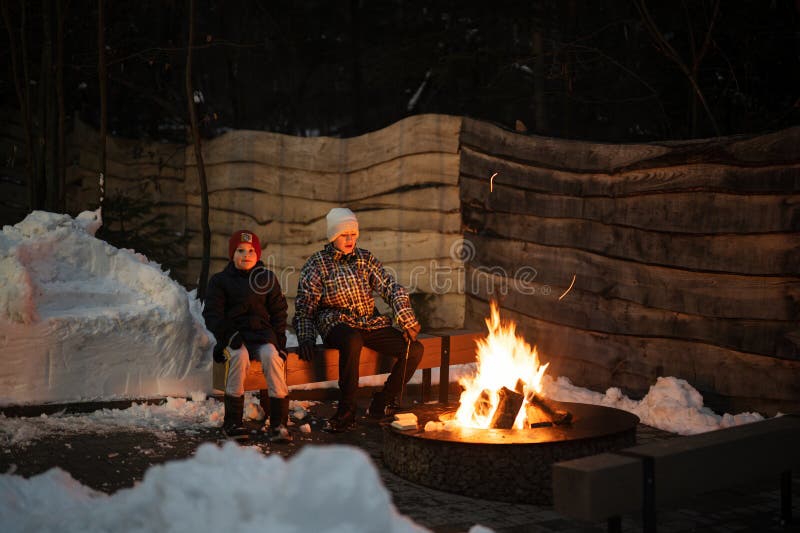Two Brothers Sit by the Fire Pit in Winter Night Stock Image - Image of ...