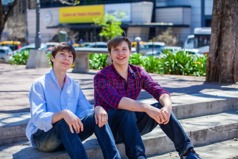 Two Brothers Sit on the Steps in the Park Stock Photo - Image of adult ...