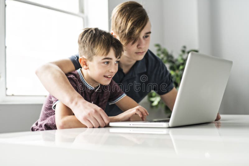 Two Brothers Using Laptop Computer To Do Their Homework Stock Image ...