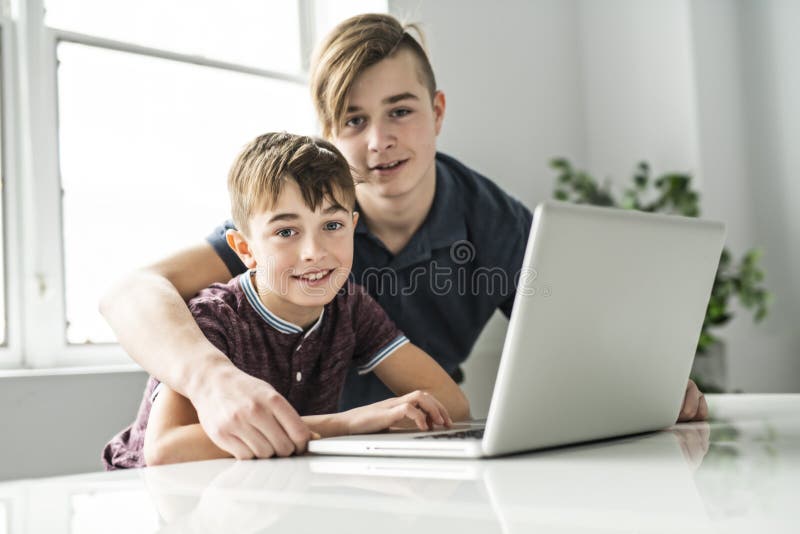 Two Brothers Using Laptop Computer To Do Their Homework Stock Image ...