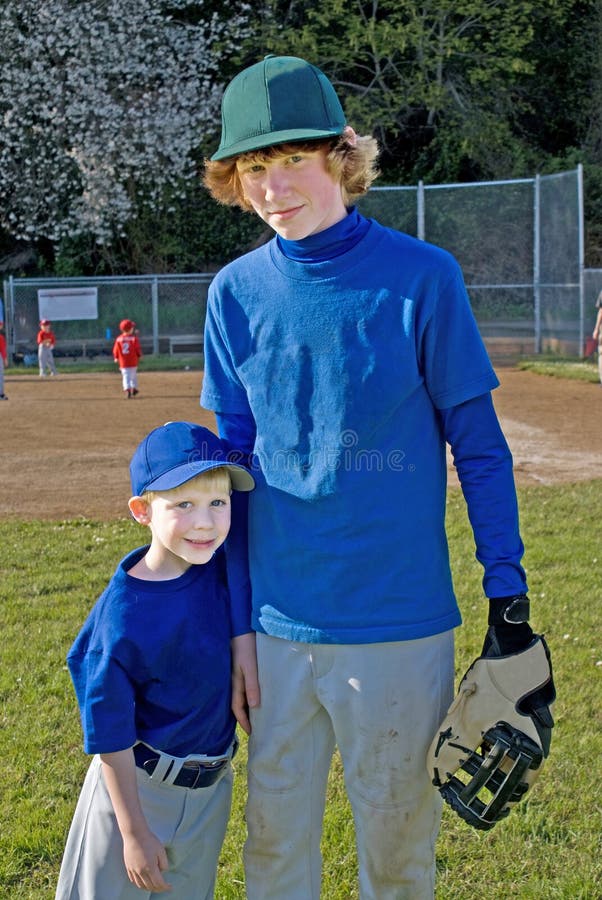 Two Brothers Wearing Baseball Uniforms. Stock Photo - Image of field ...