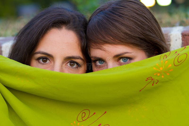 Two Brunette Girls Behind a Green Scarf Stock Image - Image of eyes ...