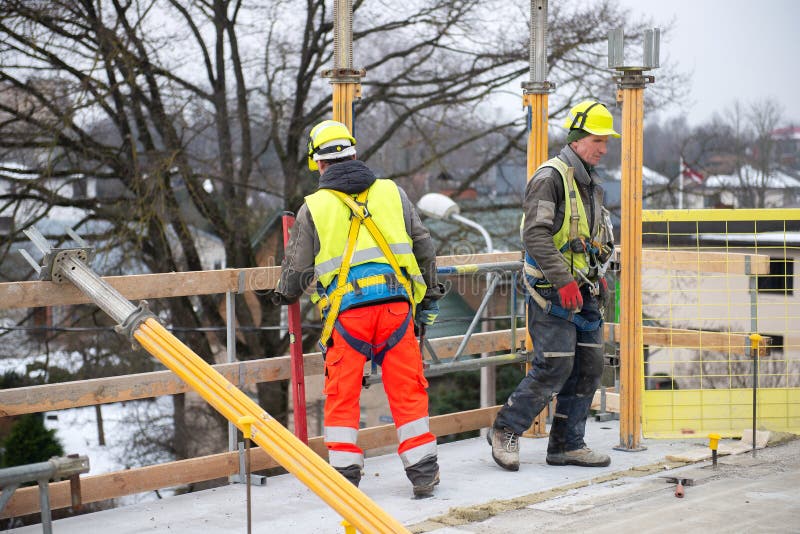 Two Builder Construction Workers in the Work Process on Building Site ...