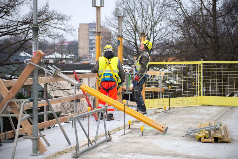 Two Builder Construction Workers in the Work Process on Building Site ...