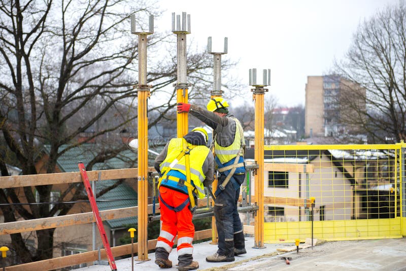 Two Builder Construction Workers in the Work Process on Building Site ...