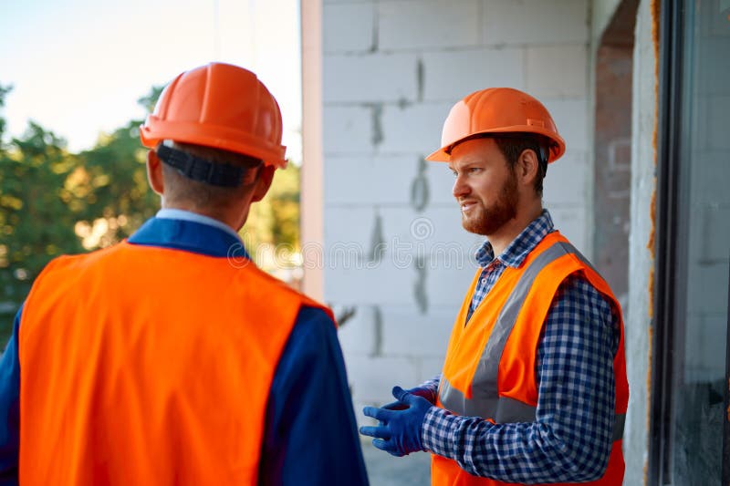 Two Builder Standing Talking at Construction Site Stock Image - Image ...