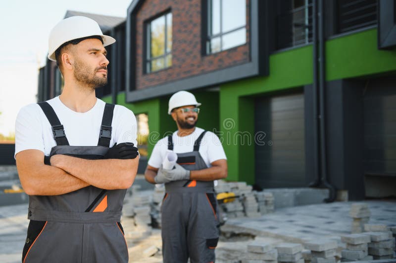 Two Builders on the Background of New Cottages. the Work is Done Stock ...