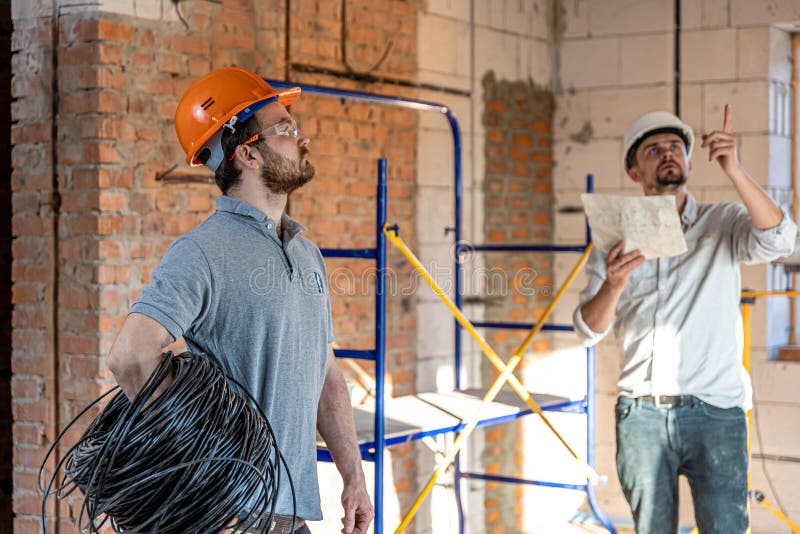 Two Builders Collaborate To Build a New Home Stock Photo - Image of ...