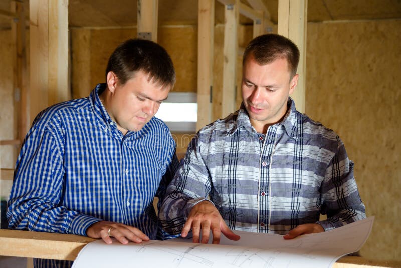 Two Builders Discussing a Building Plan Stock Photo - Image of plan ...