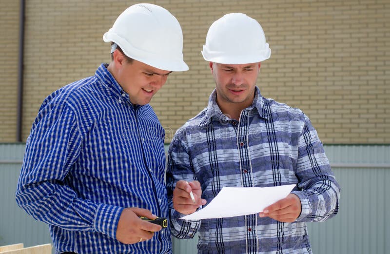 Two Builders Discussing a Building Plan Stock Photo - Image of career ...