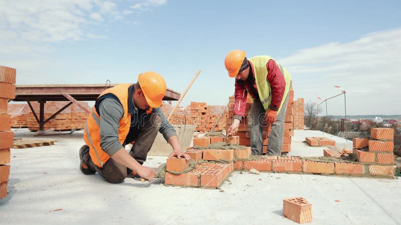 Two Builders Laying Bricks at Construction Site Stock Video - Video of ...