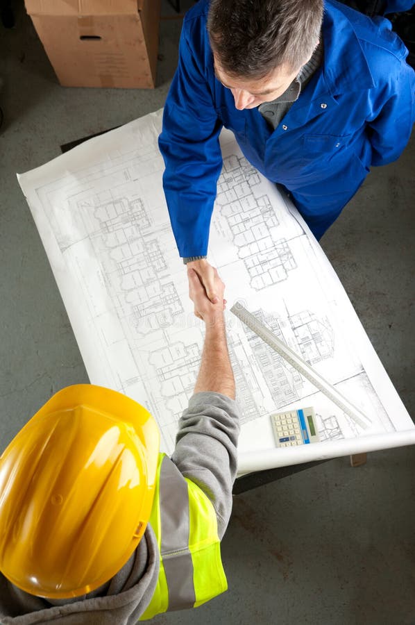 Two Builders Shake Hands Over Blueprint Stock Image - Image of ...