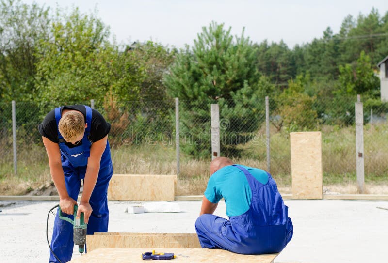 Two Builders Working on a Building Site Stock Photo - Image of ...