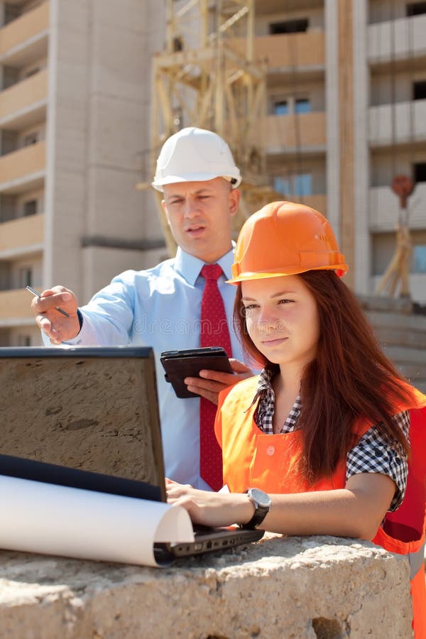 Two Builders Works on the Building Site Stock Image - Image of ...