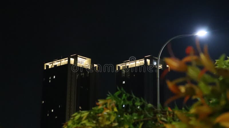 Two buildings at night stock photo. Image of yellow - 243446094