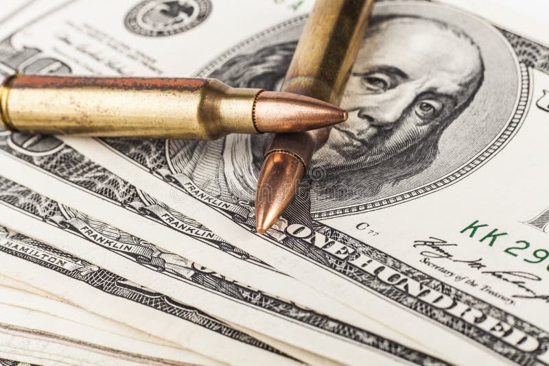 Two Bullets on Dollars stock photo. Image of finance - 66825900