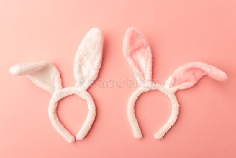 Two Bunny Ears on a Pink Background, Top View. Happy Easter Stock Photo ...