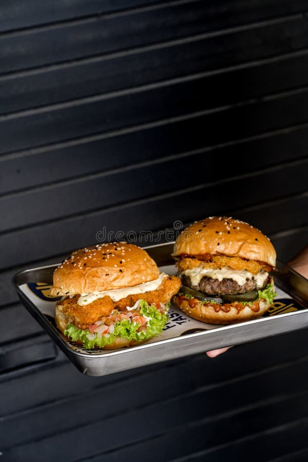Two Burgers in a Tray in Front of Garage Door Stock Image - Image of ...
