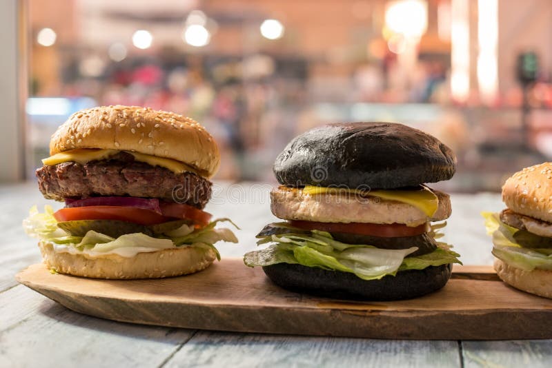 Two burgers on wood board. stock image. Image of american - 85080111