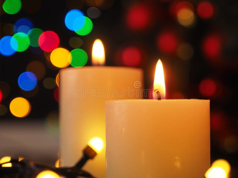 Two Burning Advent Candles with Christmas Lights Stock Image - Image of ...