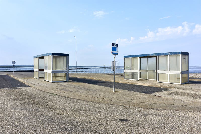 Two bus stops near the sea stock image. Image of message - 171764565