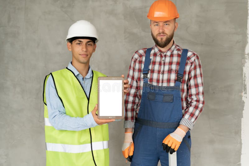 Two Business Builder People at Construction Site. Blank Screen Tablet ...
