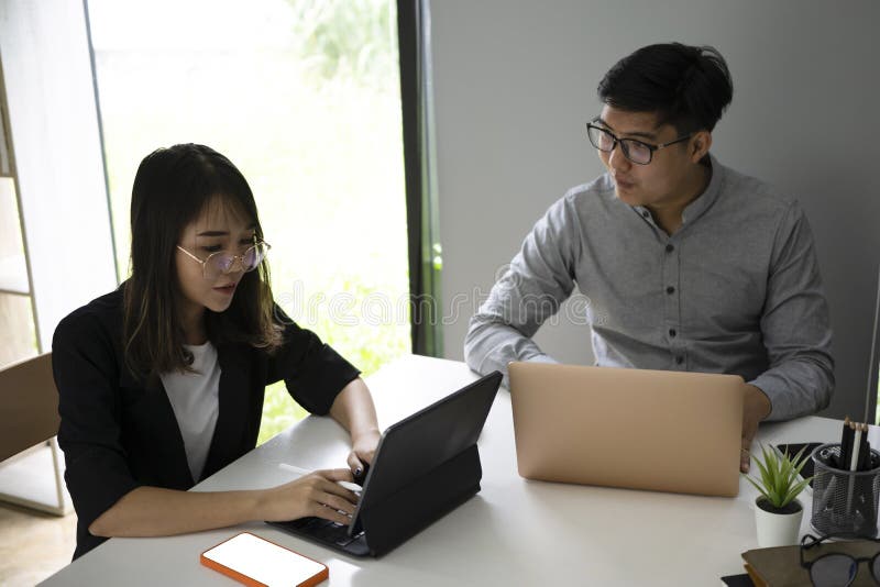 Two Business Colleagues Discussing Their Project Together in Office ...