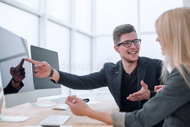 Two Business Colleagues Discussing a Work Project at the Desktop Stock ...