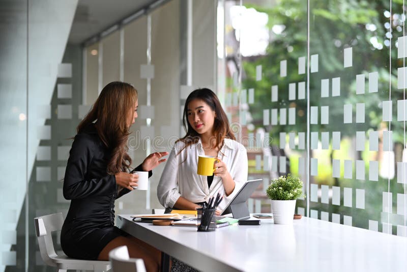 Two Business Colleagues Having Coffee Break and Talking Each Other ...