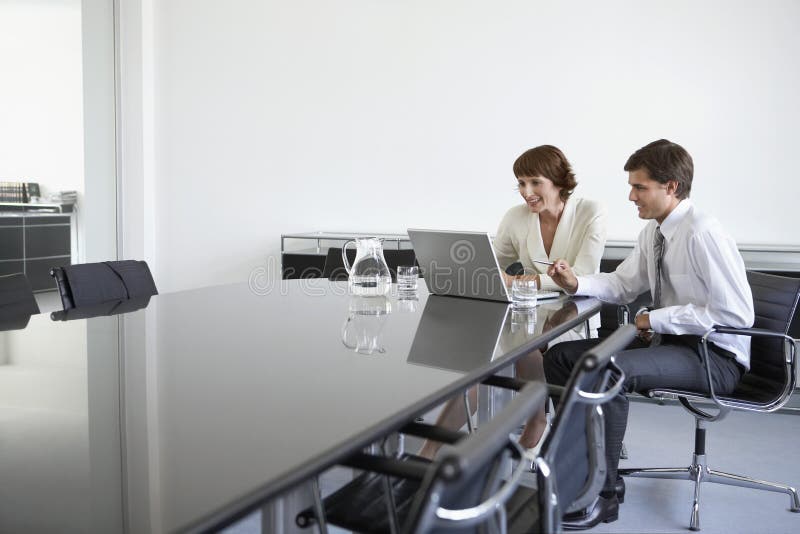 Two Business Colleagues Using Laptop at Conference Table Stock Photo ...