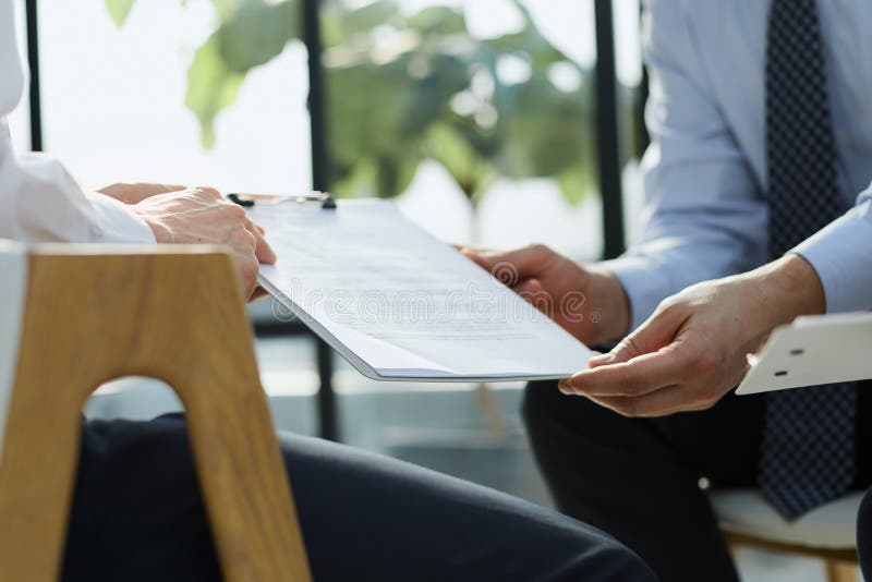 Two Business Employees Reviewing Documents in Open Folder. Stock Photo ...