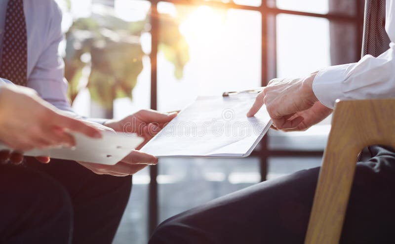 Two Business Employees Reviewing Documents in Open Folder. Stock Image ...