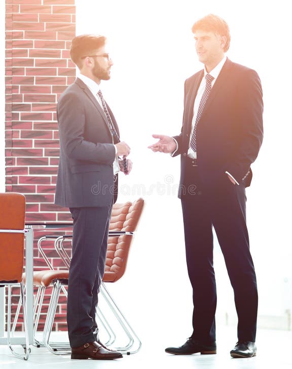 Two Business Executives Talking about Business in the Office. Stock ...