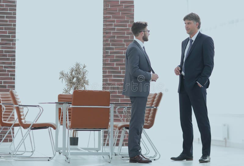 Two Business Executives Talking about Business in the Office. Stock ...