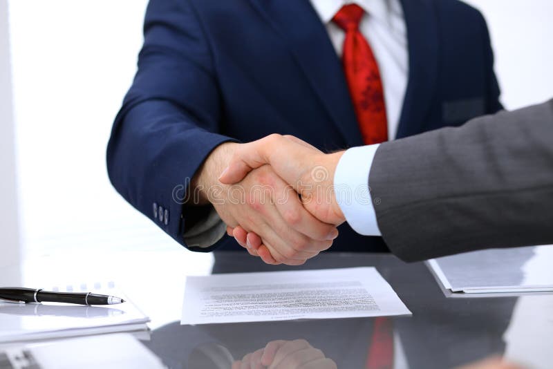 Two Business Man Shaking Hands To Each Other Above Signed Contract ...